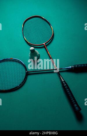 Pair of racket and a birdie on a green badminton court Stock Photo - Alamy