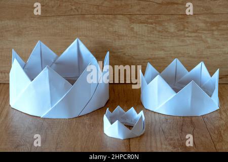Paper crown. Three paper white crowns. Royal family, royal dynasty ...