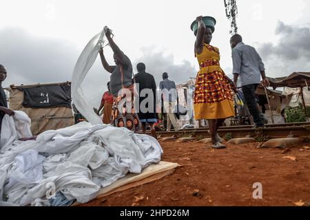 Residents walk past the busy streets in Kibera Slum, Nairobi. A view ...