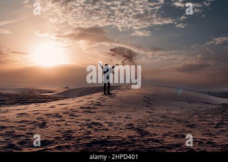 Woman throwing sand on the dunes of a beach at sunset. Freedom Stock ...
