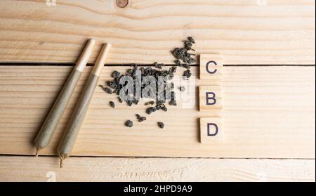 Word CBD written with wooden blocks, along with medical marijuana ...