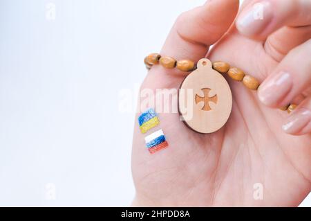Orthodox Christ and drawned Russian and Ukrainian flags in hand Stock ...