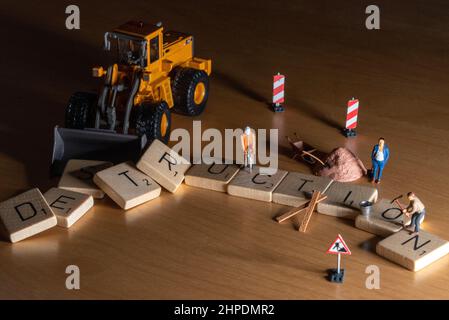 Miniature figures demolishing the word "destruction Stock Photo - Alamy