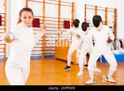 active fencers at fencing workout, practicing attack movements in ...
