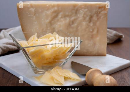 Flakes of parmesan cheese, italian hard parmigiano-reggiano cheese from ...