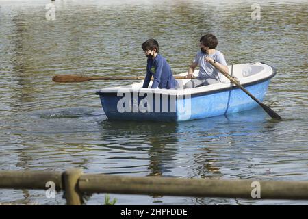 Kids riding in a rowboat in a Europe Park, Madrid, Spain Stock Photo ...