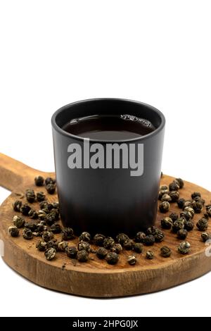 White teapot with eyes on a green background. Funny dishes with false ...