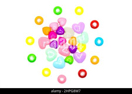 Accessories for needlework form of bright colored hearts on a white ...