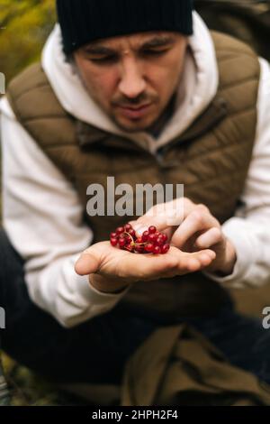 A vertical shot of a hiker looking up at a starry night sky in Parco ...
