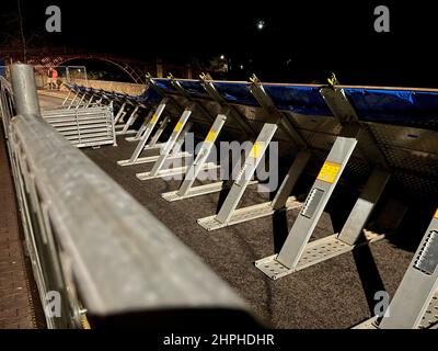 Workmen build flood defences at the River Severn in Ironbridge ...