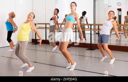 Group of active women practicing energetic dance in a studio Stock ...