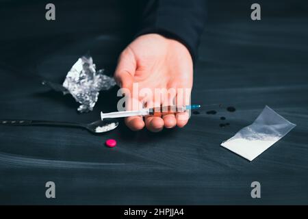 Drug addict reaches for another dose of drug. Concept of addiction ...