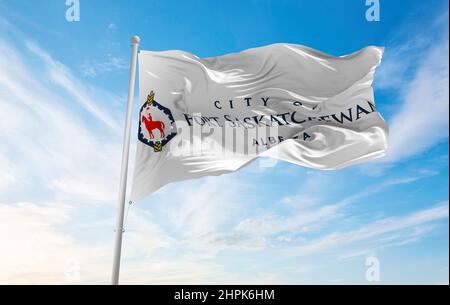 flag of Fort Saskatchewan , Canada at cloudy sky background on sunset ...