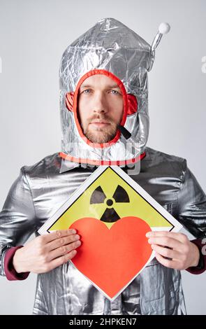 Young bearded man with paper heart for Valentine's Day on yellow ...