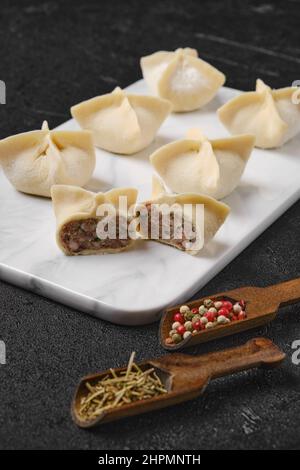 Homemade spicy beef dumplings on marble serving plate Stock Photo - Alamy
