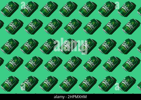 Pattern of green Heineken Dutch beer cans with hard shadow, on top, on ...