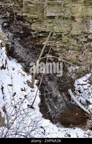 View of waterfall flowing over limestone cliff, Thornton Force, River ...