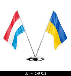 Ukraine and Luxembourg two flags on flagpoles and blue cloudy sky ...
