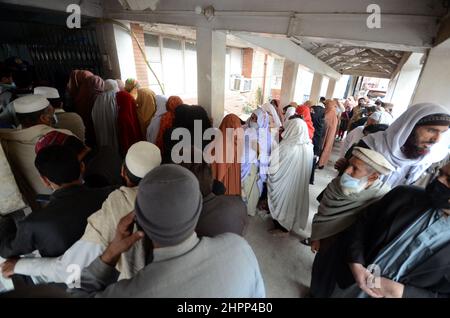 Peshawar, Pakistan. 22nd Feb, 2022. People stand in a queue to get OPD ...