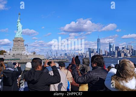 Passengers enjoy the view on a city line ferry at sunset in Istanbul ...