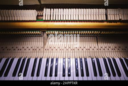 Details of an open upright piano, strings and structure closeup view ...