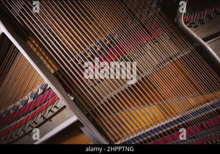 Details of an open upright piano, strings and structure closeup view ...