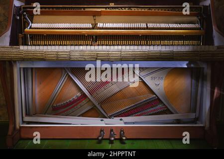 Details of an open upright piano, strings and structure closeup view ...