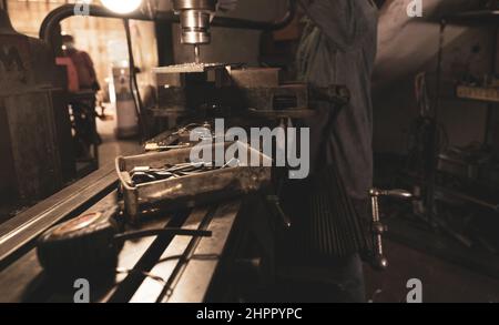 technician working on a lathe and tools to work. Technicians, workers ...