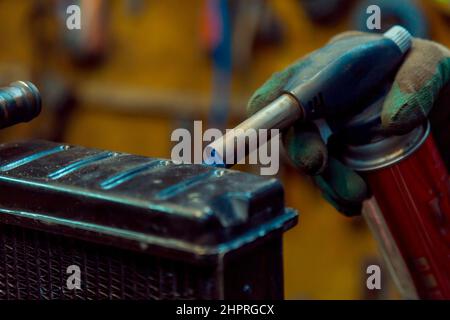 Welding a large car radiator with a gas torch Stock Photo - Alamy