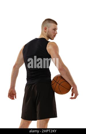Back view of muscled man, basketball player posing with two balls ...