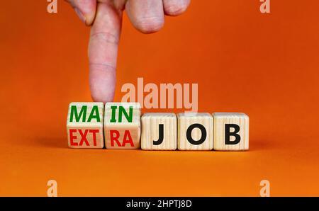 Extra or main job symbol. Businessman turns wooden cubes and changes ...