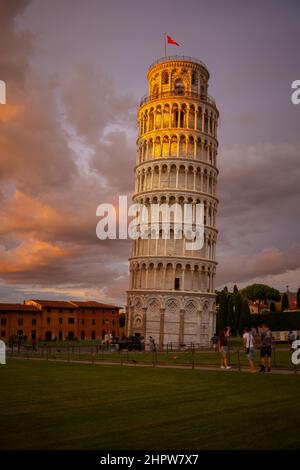 The Cathedral and the Leaning Tower of Pisa glow in the pink light of ...