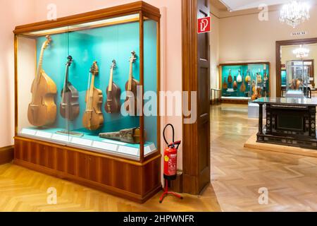 Showcase with bowed string instruments in Weltmuseum Wien, Austria ...