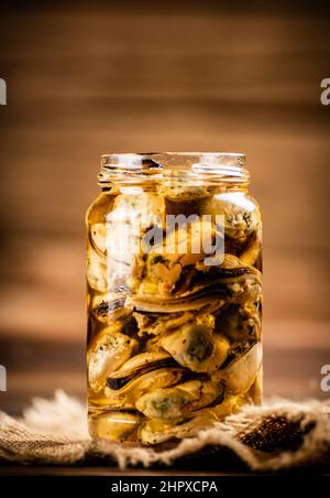 Marinated mussels on wooden background. Seafood dishes Stock Photo - Alamy