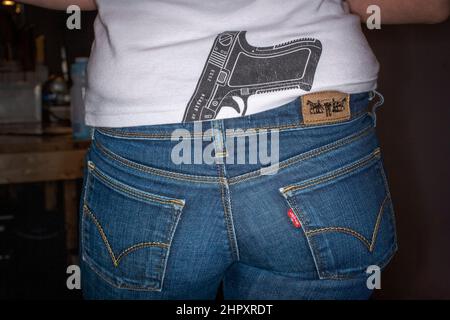 gun in his pants t-shirt Stock Photo - Alamy