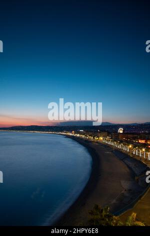 Sunset over the Baie des Anges, the Promenade des Anglais and the city ...