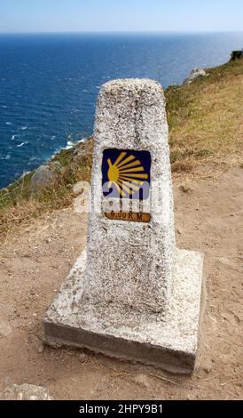 End of Saint James Way sign and lighthouse of Finisterre in Galicia ...