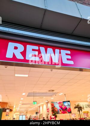 Sign REWE logo above the supermarket entrance Germany Europe Exterior ...