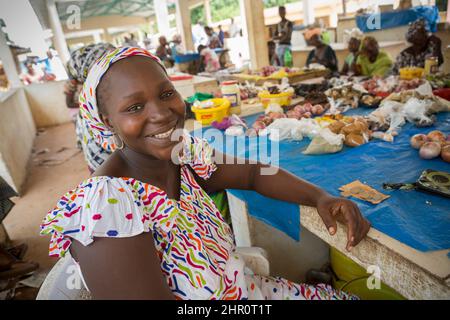 An African woman sells produce at her market stall in Tanaff, Senegal ...