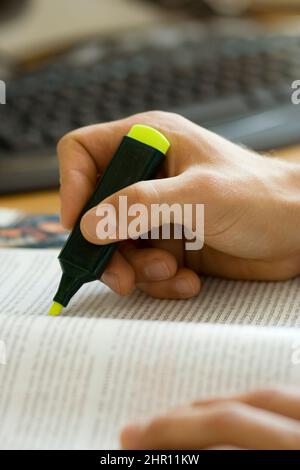Student Highlighting A Page Stock Photo - Alamy