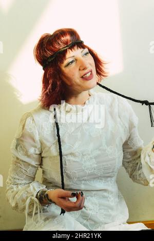 Redhead woman with movement hair. Studio shot of carefree redhead woman ...