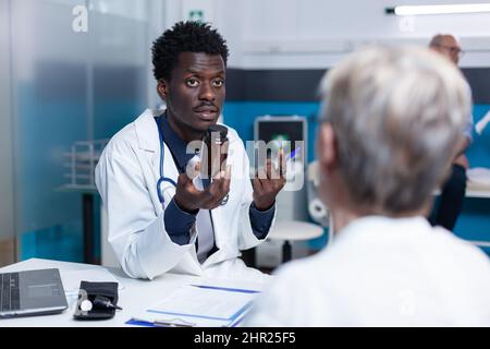 African american medic presenting the diagnostic reports to a female ...