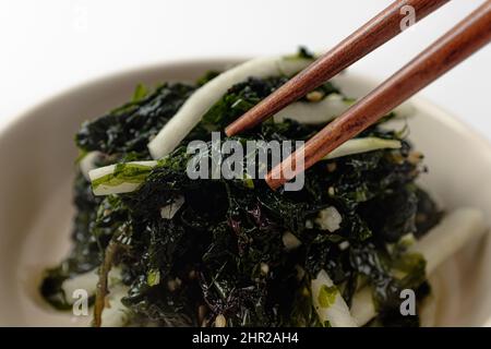 pickled green laver on a white background Stock Photo - Alamy