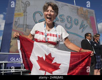 Trap shooter Susan Nattrass smiles as she displays the Canadian flag as ...