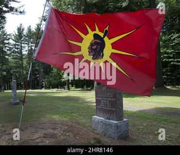 A Mohawk warrior flag flies in front of the Kanesatake Mohawk band ...
