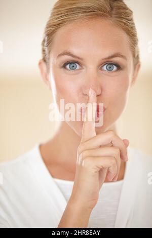Keep quiet sign. Portrait of a beautiful woman in casual clothing ...