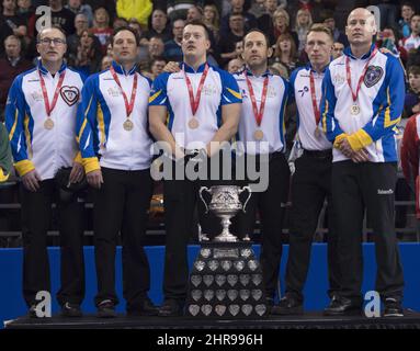 Team Canada second Scott Pfeifer (left) and lead Marcel Rocque look on ...