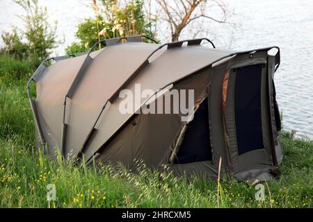 Carp tent on the grassy riverbank Stock Photo - Alamy
