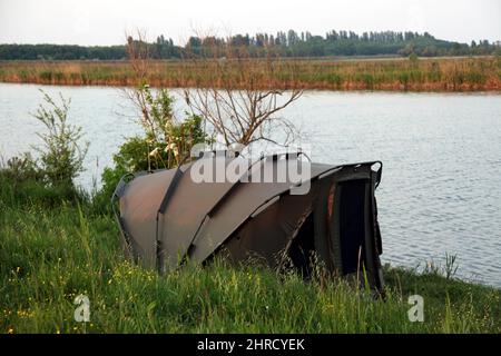 Carp tent on the grassy riverbank Stock Photo - Alamy