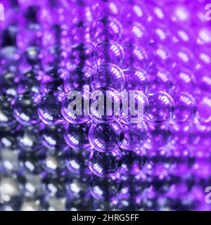 Macro shot of lit purple and grey marbles forming a pyramid Stock Photo ...